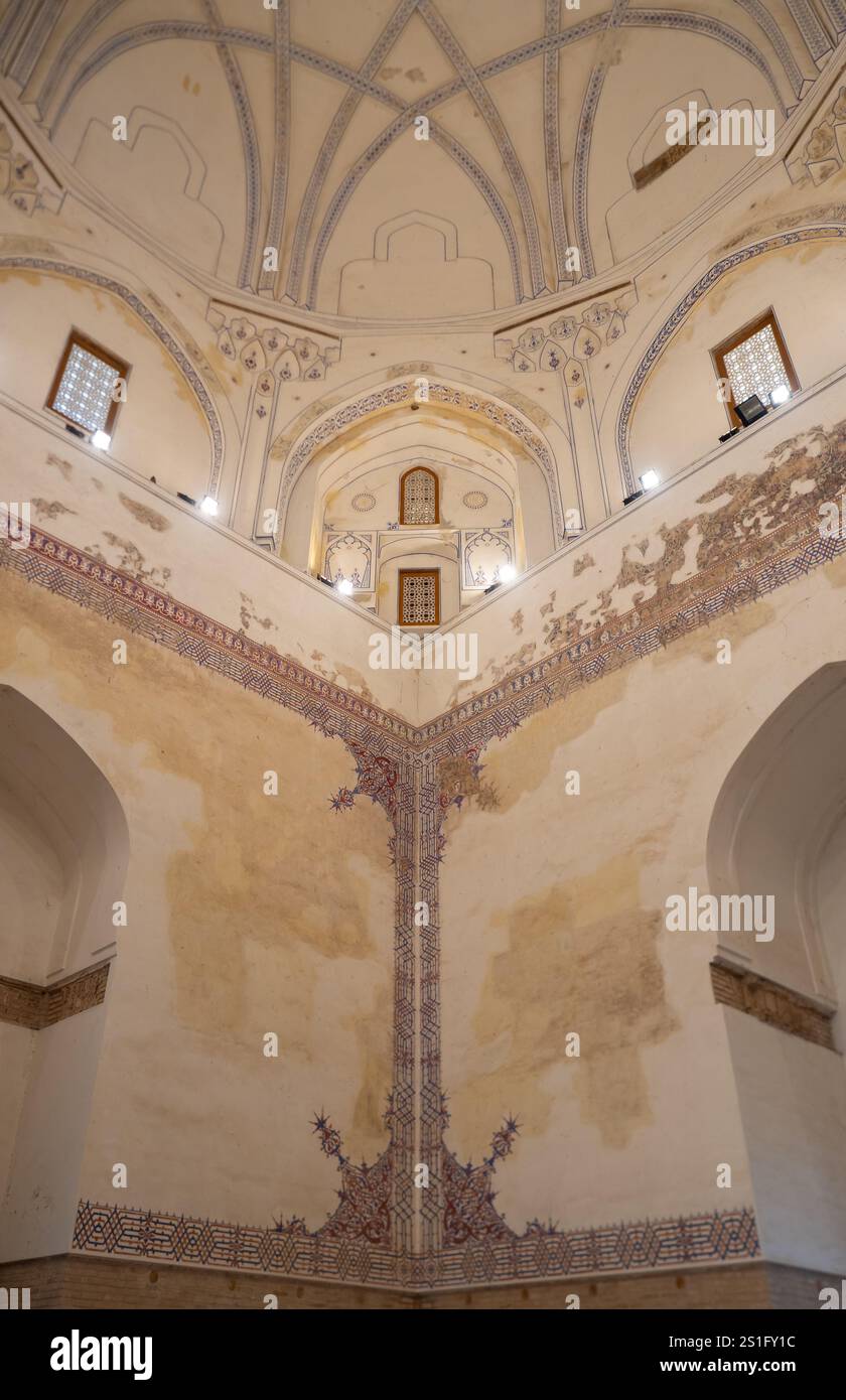 Painted red and blue designs on the walls, around the arched alcoves ...