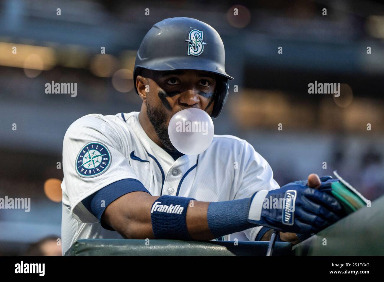 Seattle Mariners' Victor Robles is pictured blowing a bubble during a ...