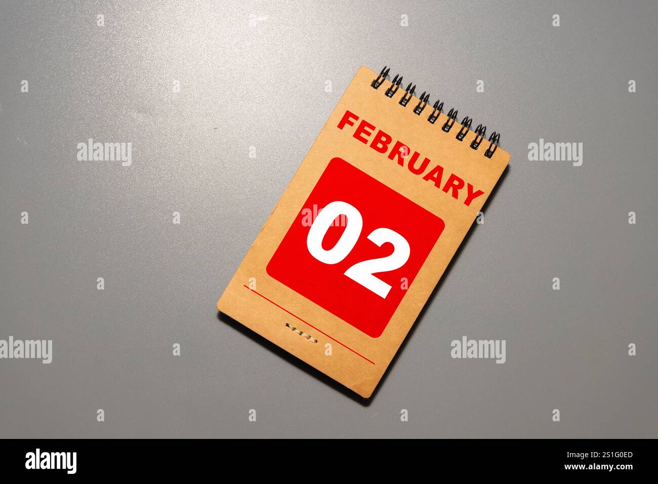 Calendar with date February 2nd on light blue background, closeup ...