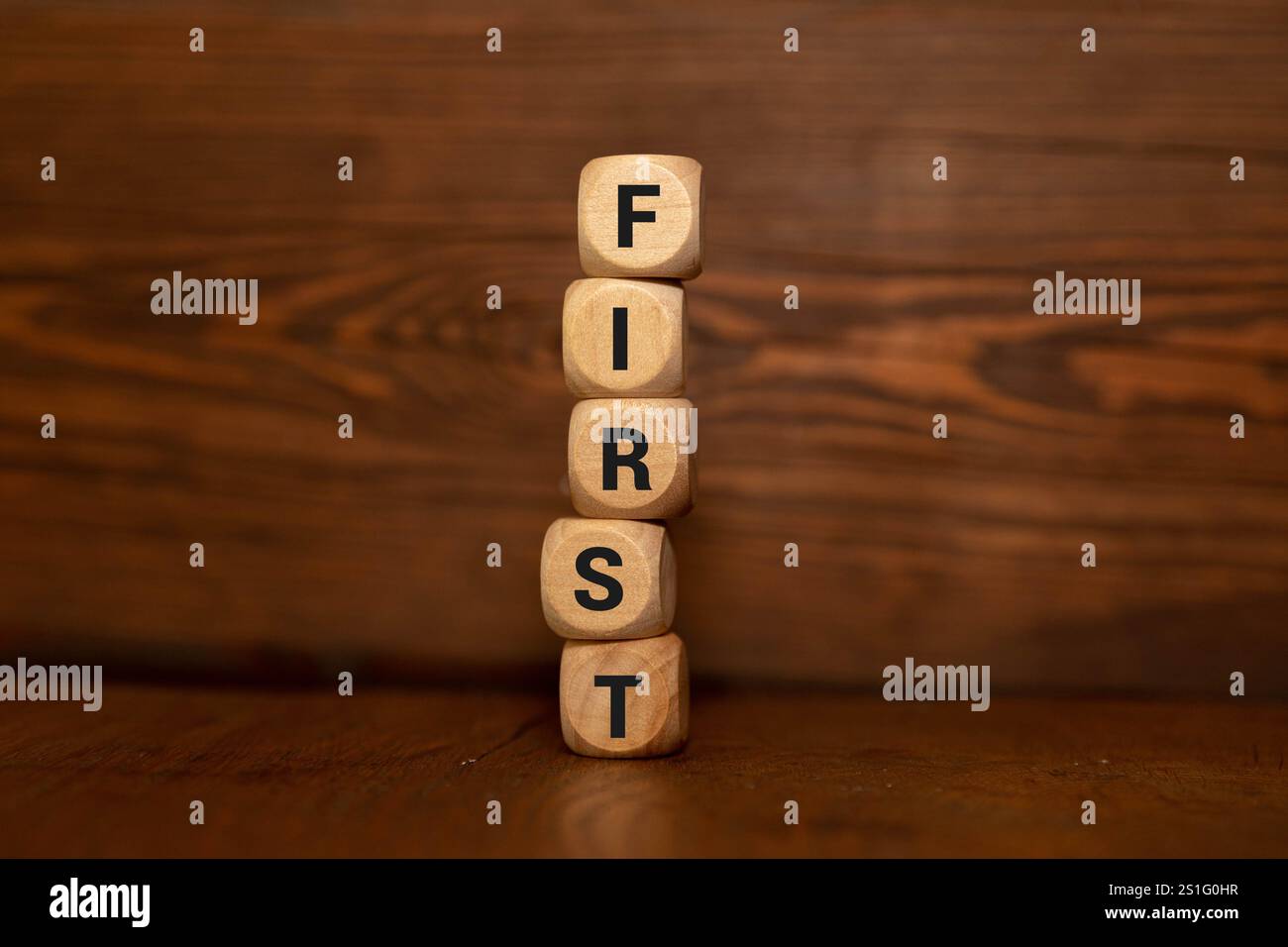 First in out symbol. Businessman turns wooden cubes and changes words ...