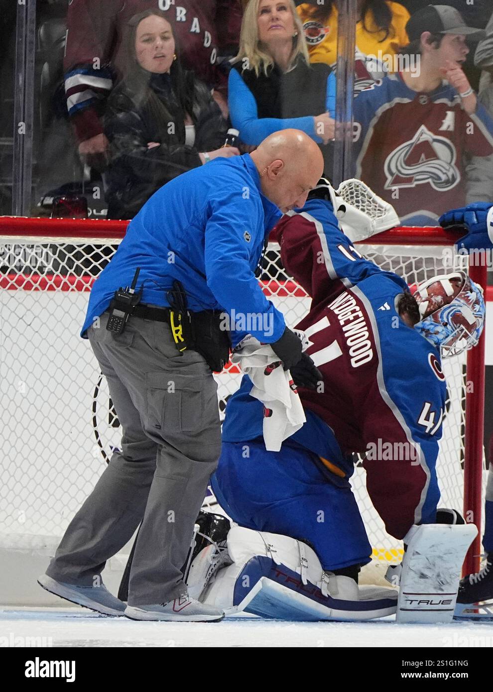 Colorado Avalanche head trainer Matthew Sokolowski helps up goaltender ...
