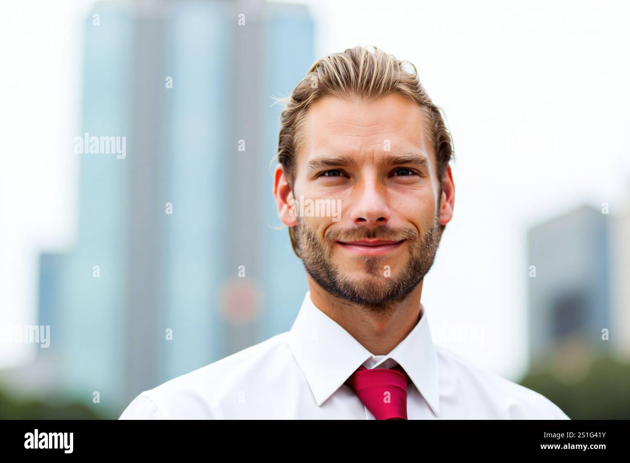 Portrait of a young, successful businessman smiling confidently in ...