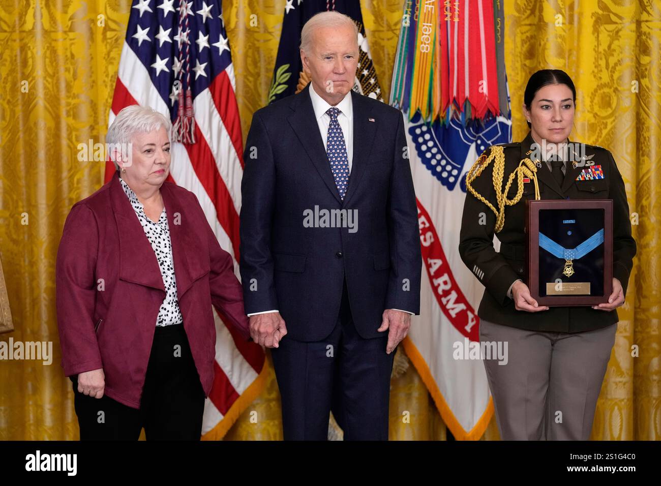 President Joe Biden, center, stands with Laura Blevins, left, before ...