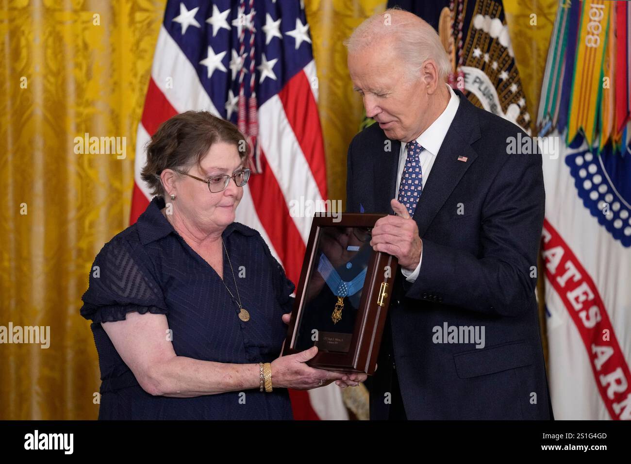 President Joe Biden talks with Debra Nelson McKnight after presenting ...