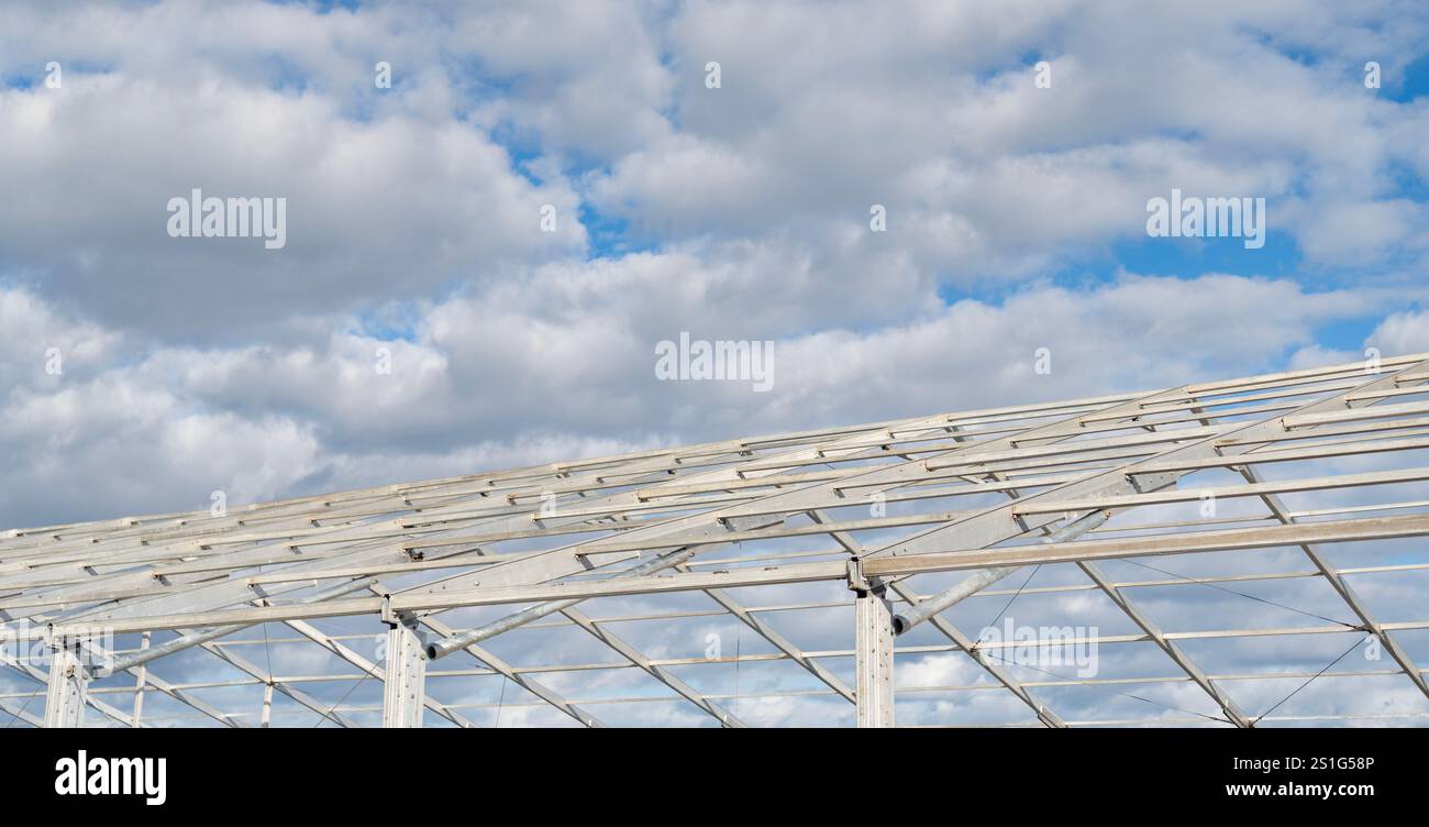 Installation of metal structure at cloudy sky. Metal construction. Structural design engineering ...