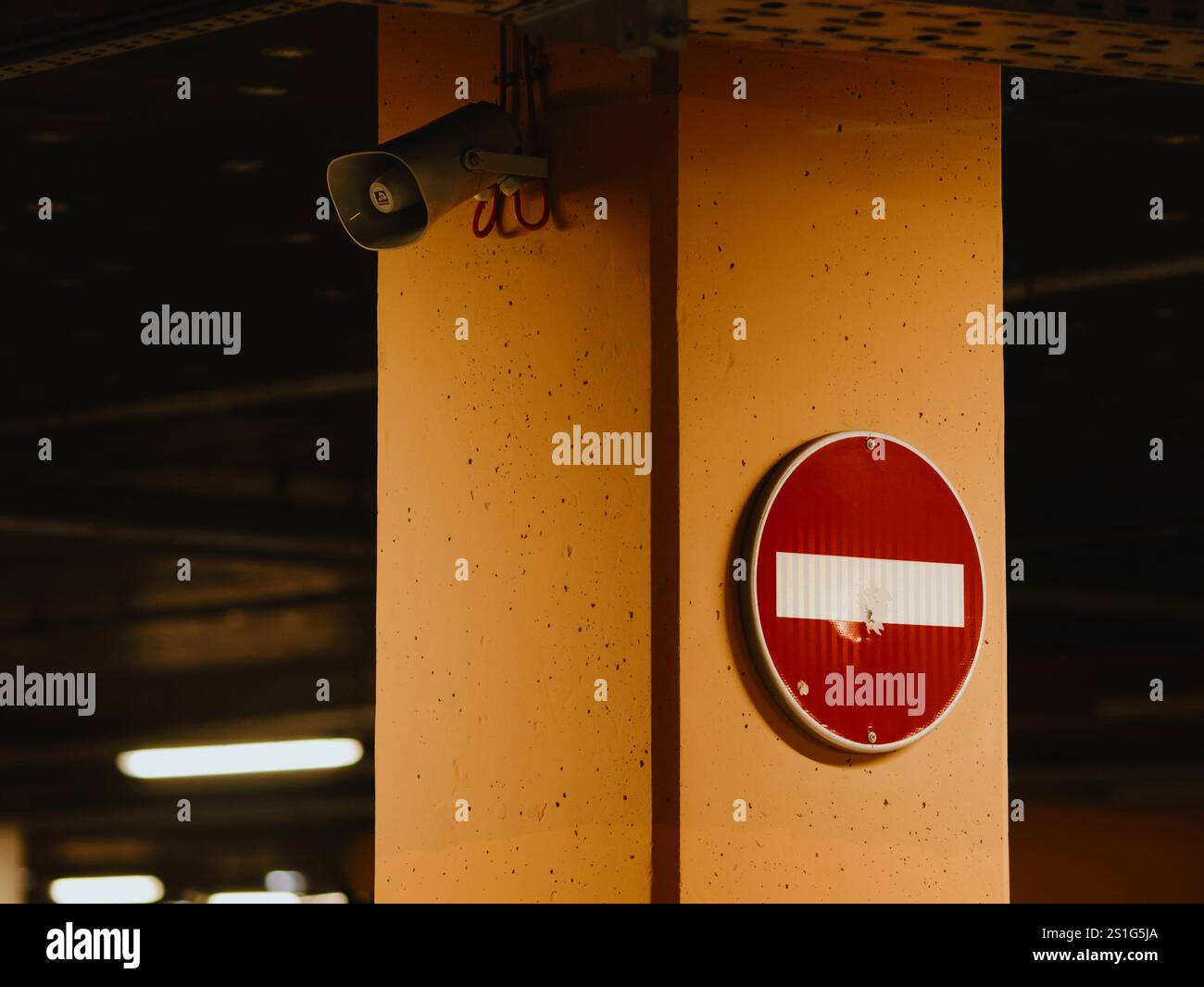 Loudspeaker and prohibition sign on a column in an underground parking ...