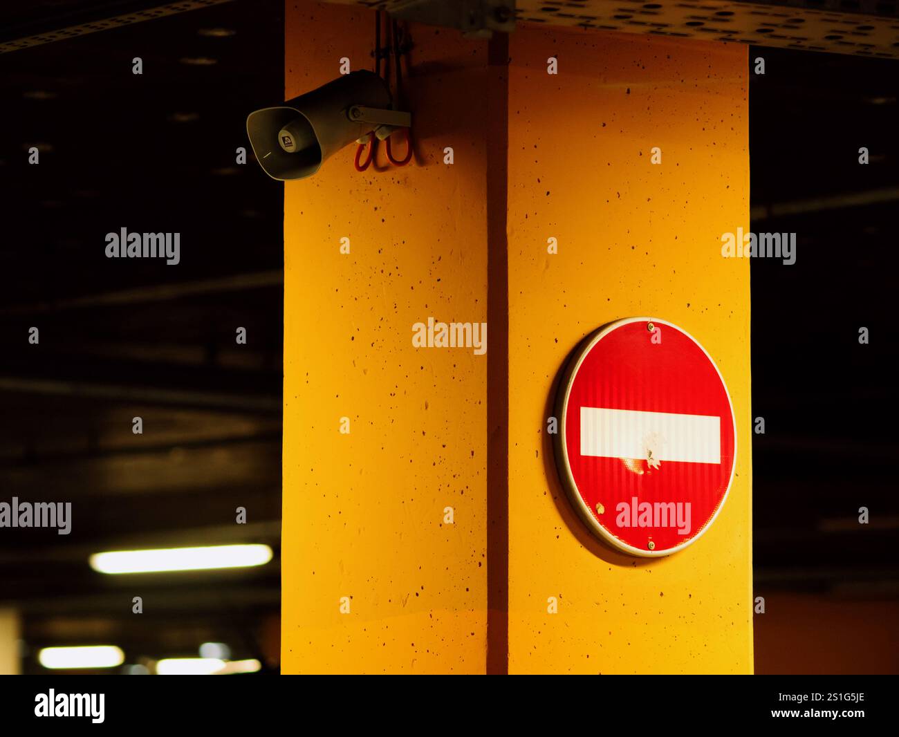 Loudspeaker and prohibition sign on a column in an underground parking ...
