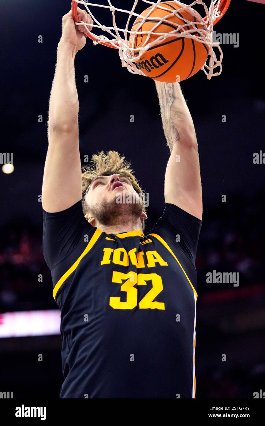 Iowa forward Owen Freeman (32) dunks the ball during the first half of ...