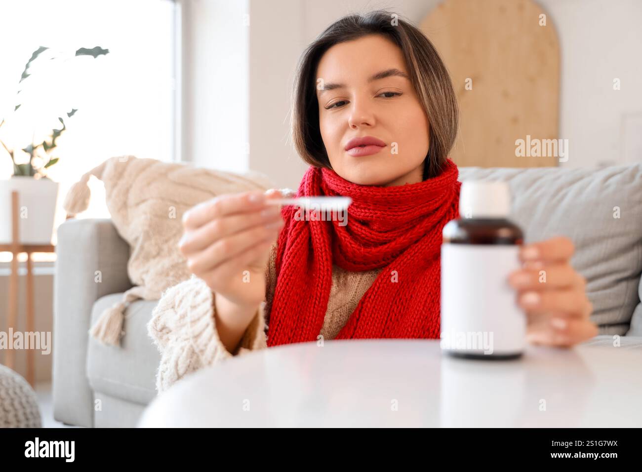 Sick young woman taking cough syrup from table at home, closeup Stock ...