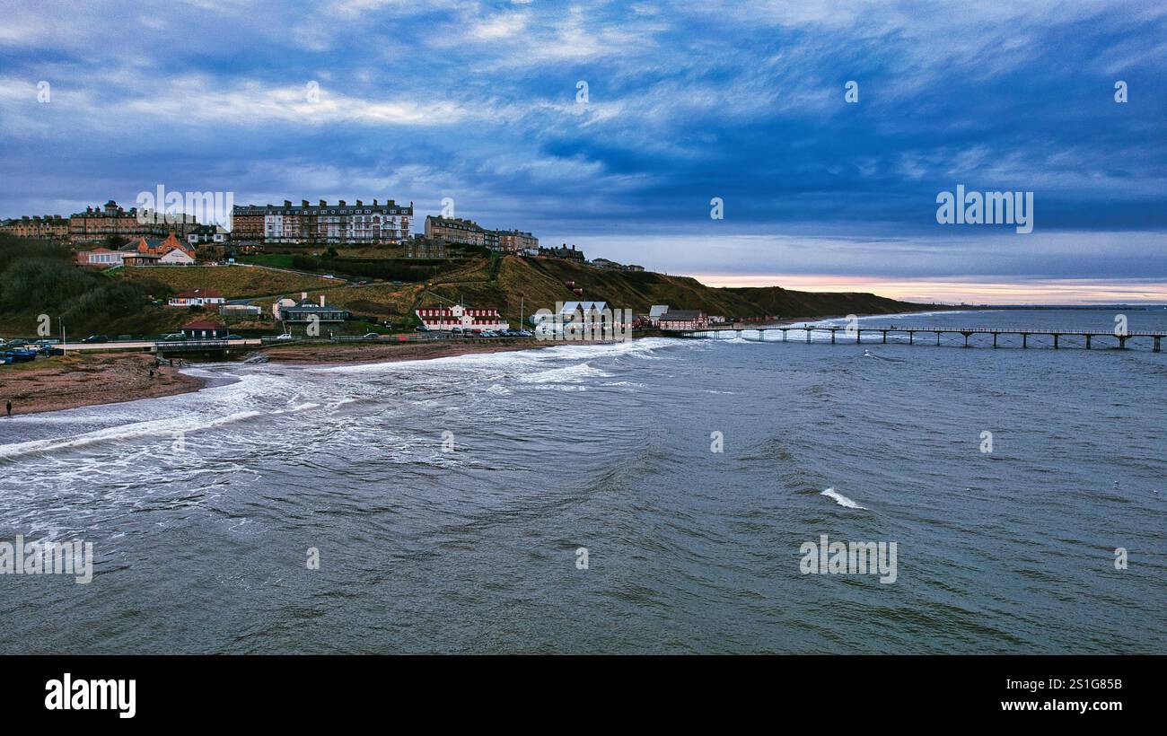 Coastal town skyline with multi-story buildings on a cliff overlooking ...