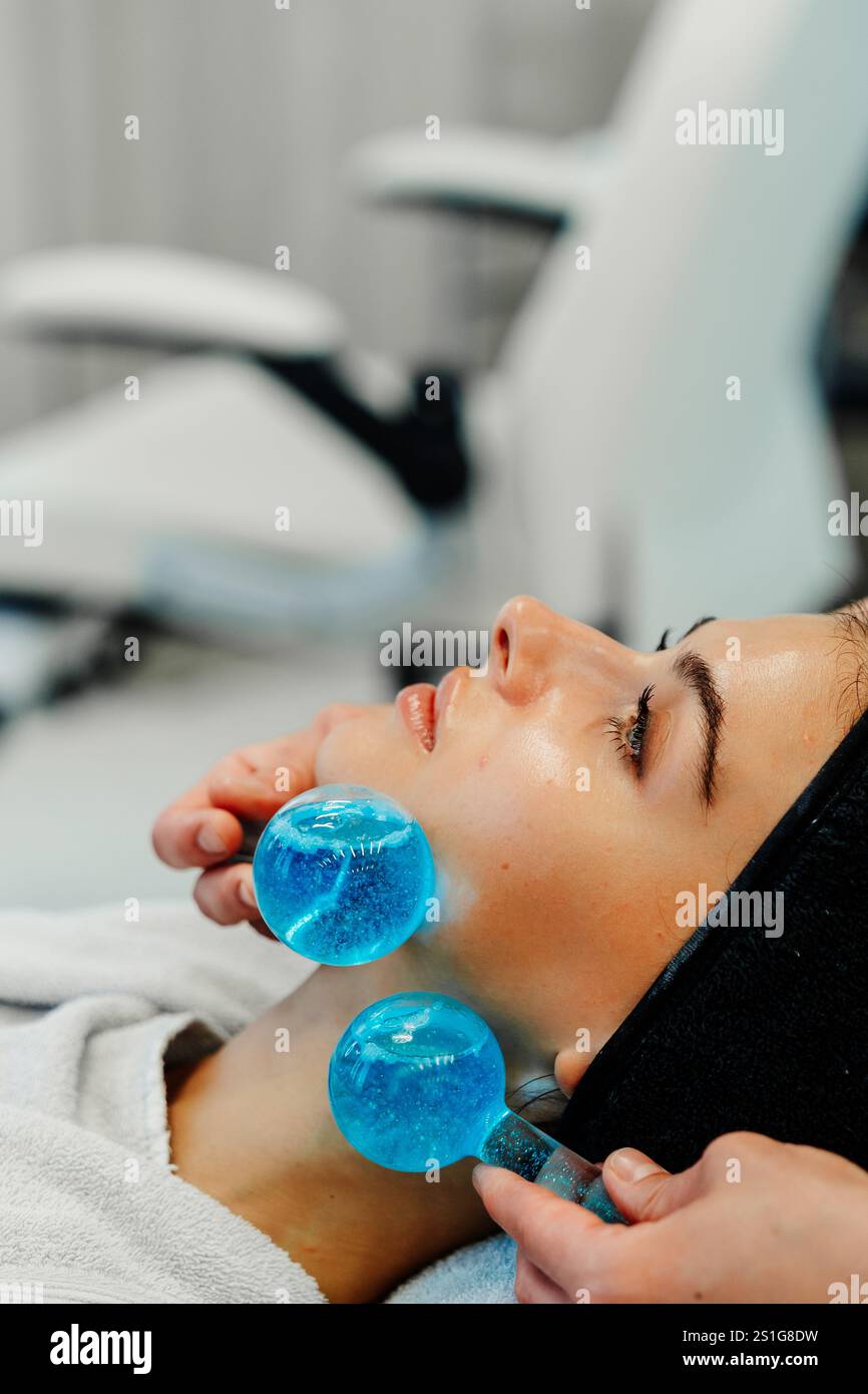 Rejuvenating Facial Treatment With Cooling Gel Balls At A Spa Stock