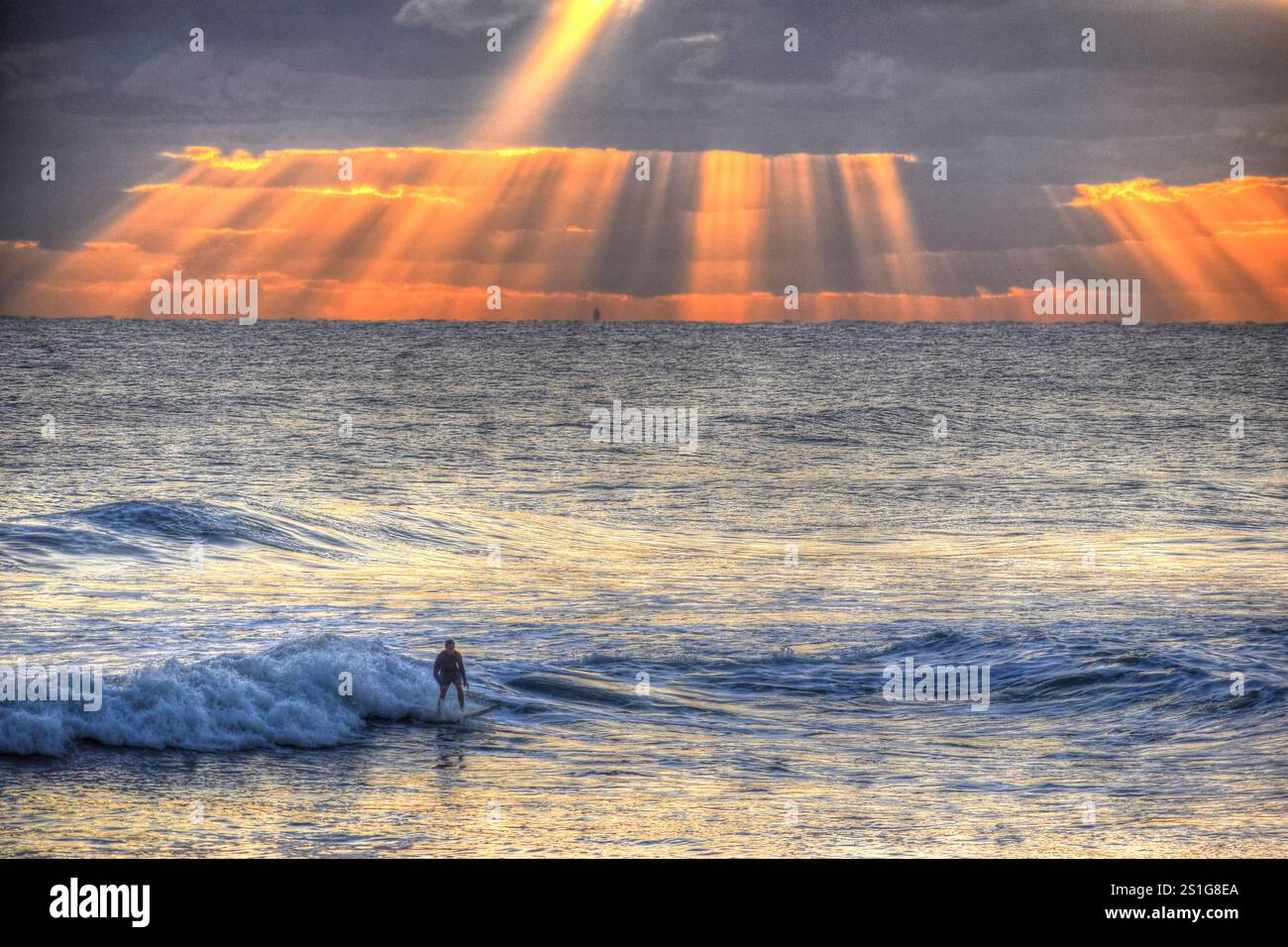 Sunrise Surfer Juno Beach Pier, Florida. Surfer Catches a Wave with ...