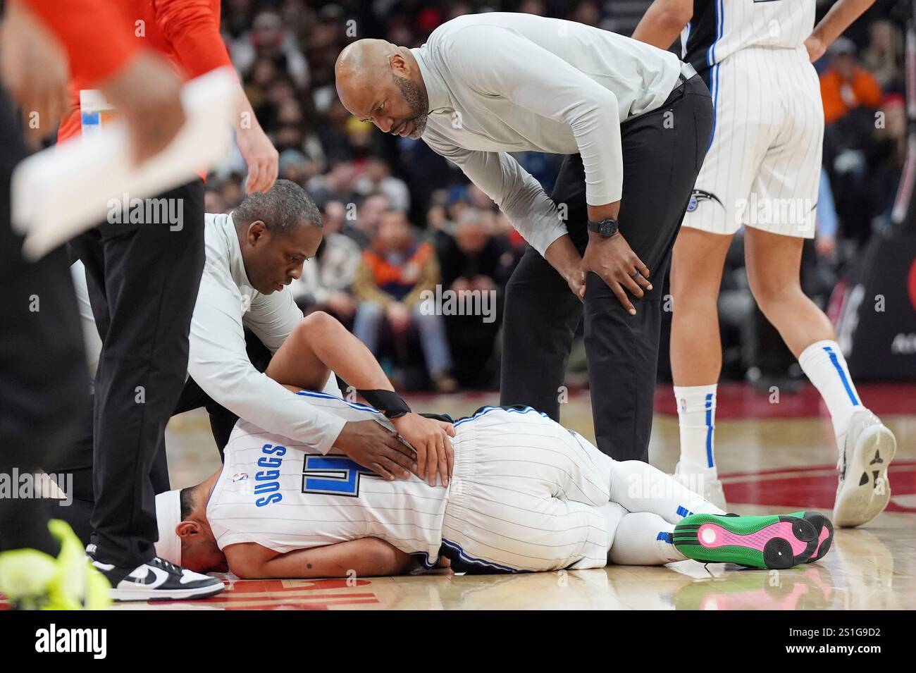 Orlando Magic head coach Jamahl Mosley, right attends to guard Jalen ...