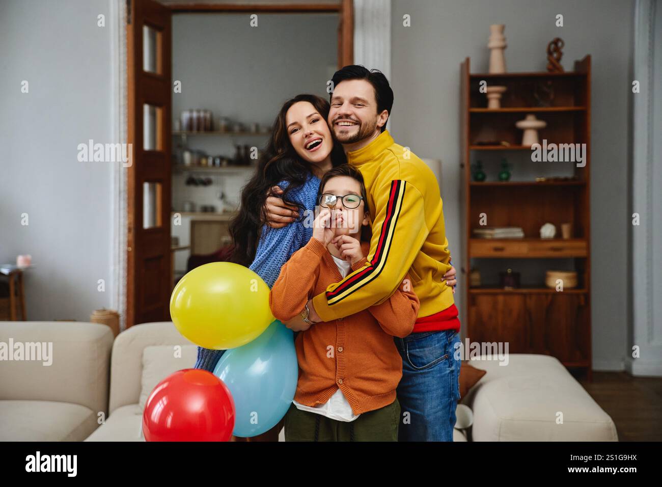 Happy family celebrating a special occasion with colorful balloons ...