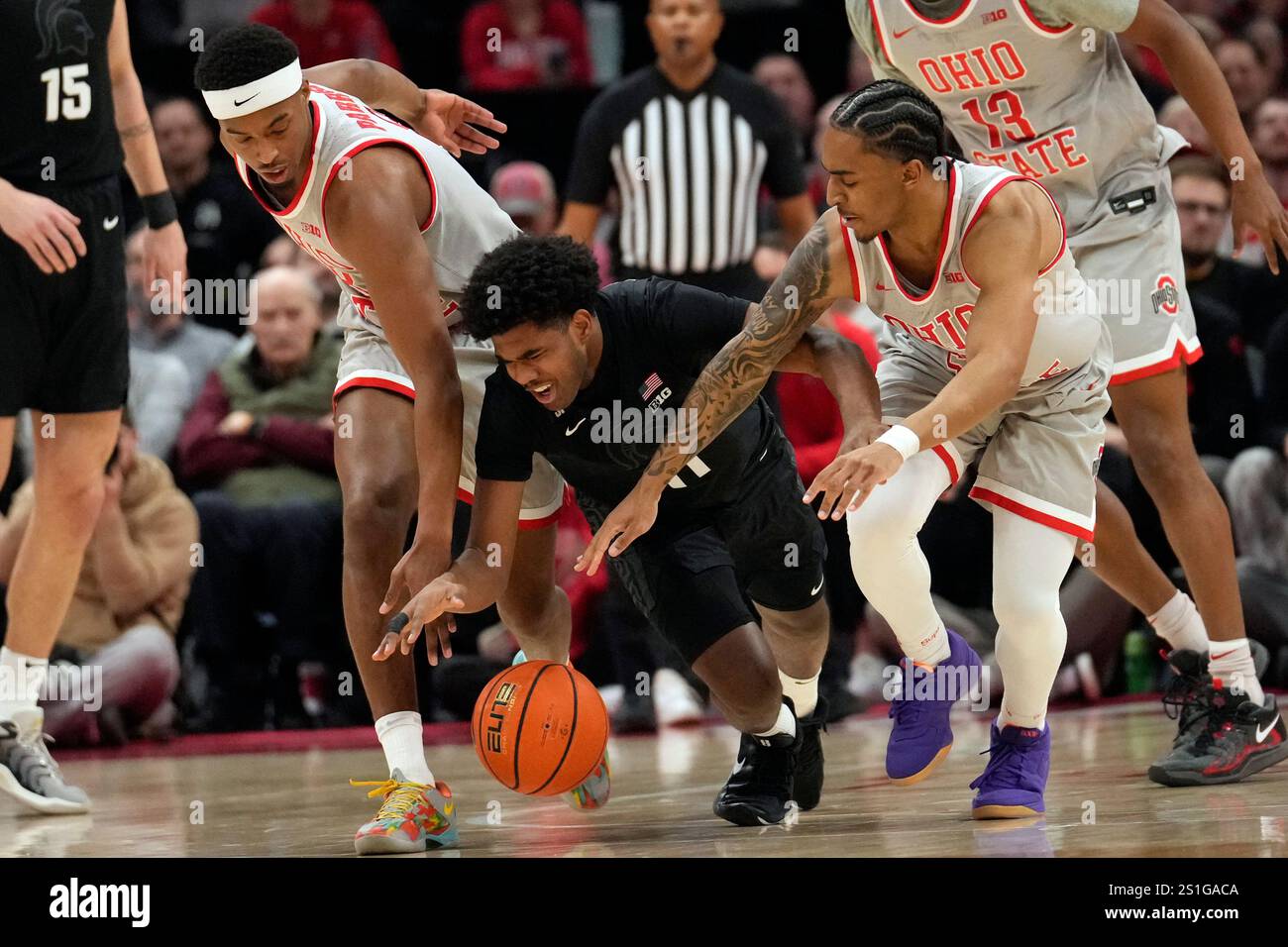 Ohio State guard Micah Parrish, left, Michigan State guard Jase Richardson, center, and Ohio ...