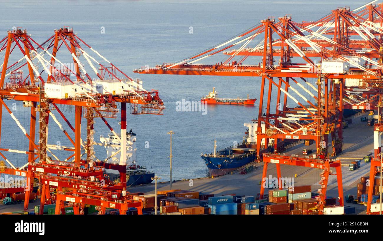 QINGDAO, CHINA - JANUARY 3, 2025 - Cargo ships load and unload ...