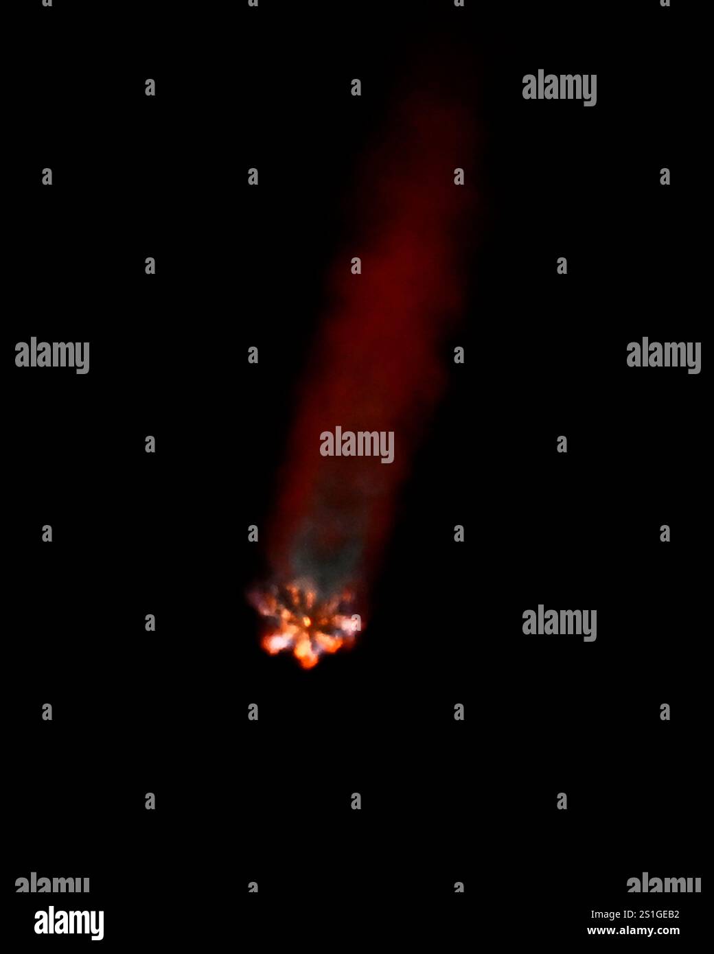 The exhaust of the SpaceX Falcon 9 rocket glows red at altitude as it ...