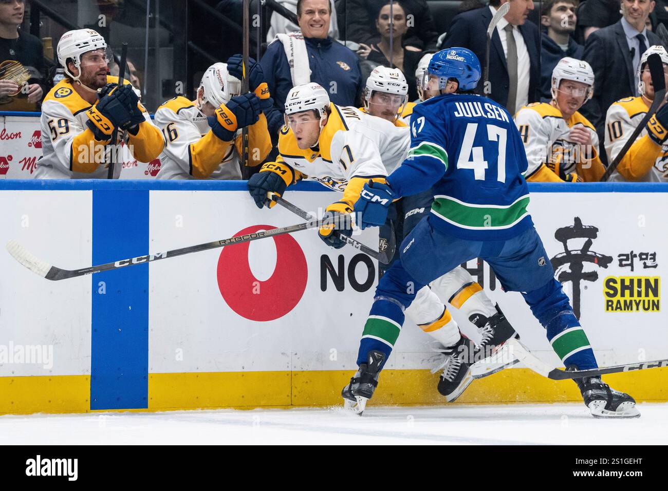 Vancouver Canucks Noah Juulsen (47) hits Nashville Predators Mark ...