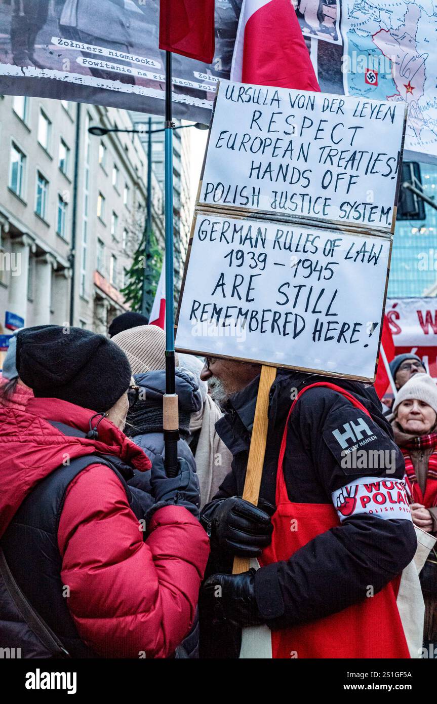 Protestors discuss the demonstration while holding placards demanding ...