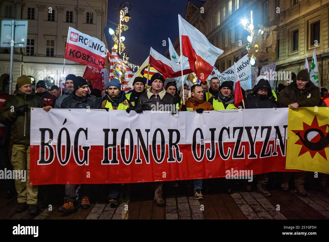 Protestors march behind a banner which bears the motto of the Polish ...