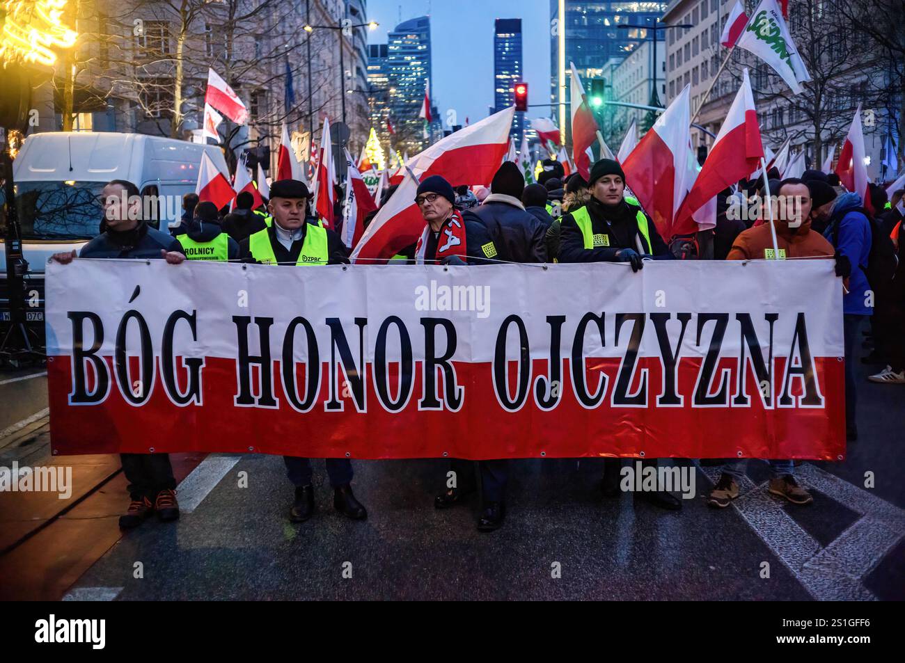 Protestors march behind a banner which bears the motto of the Polish ...
