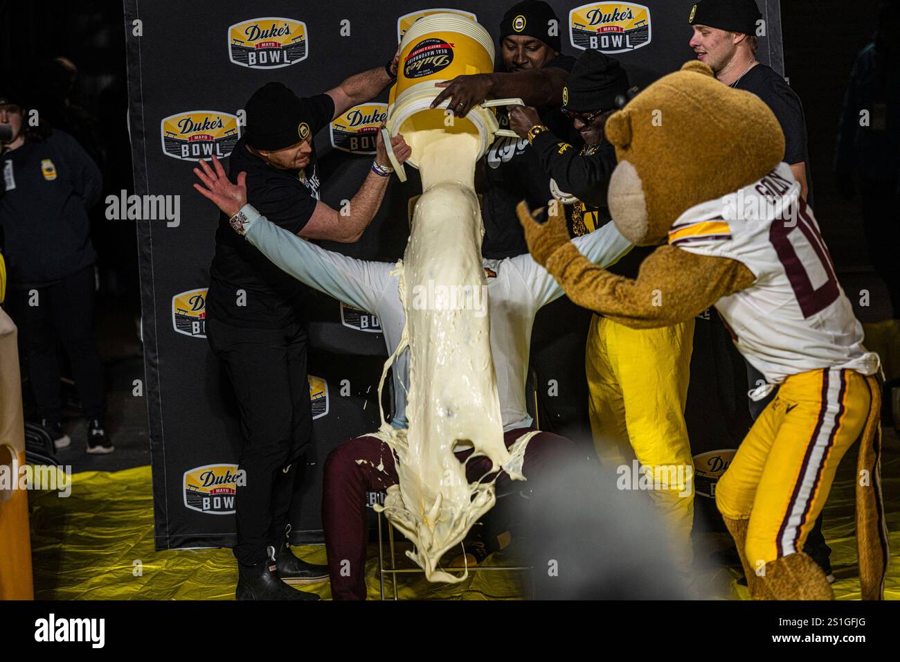 Minnesota head coach P.J. Fleck, center, receives the mayo dump after ...