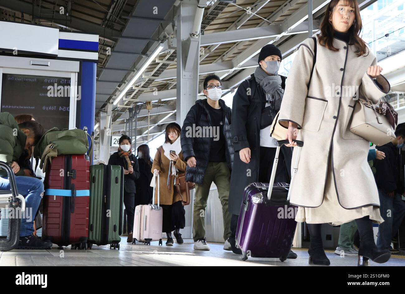A platform of Shinkansen bullet train is crowded with passengers at JR ...