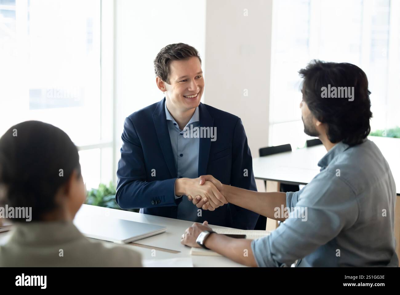 Positive successful Caucasian business leader man giving handshake ...