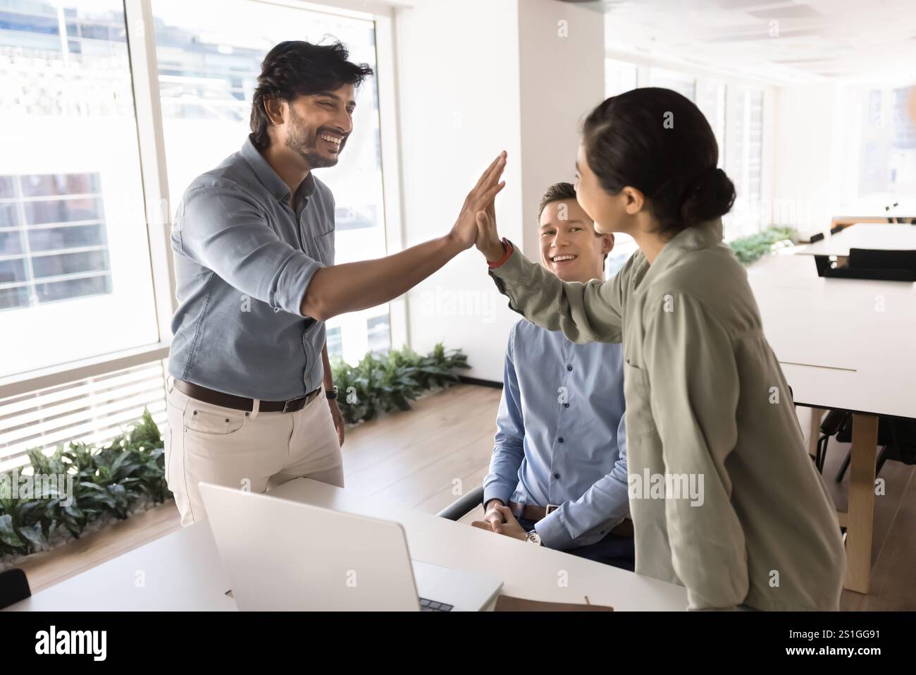 Cheerful Indian startup colleagues clapping high five hands Stock Photo ...