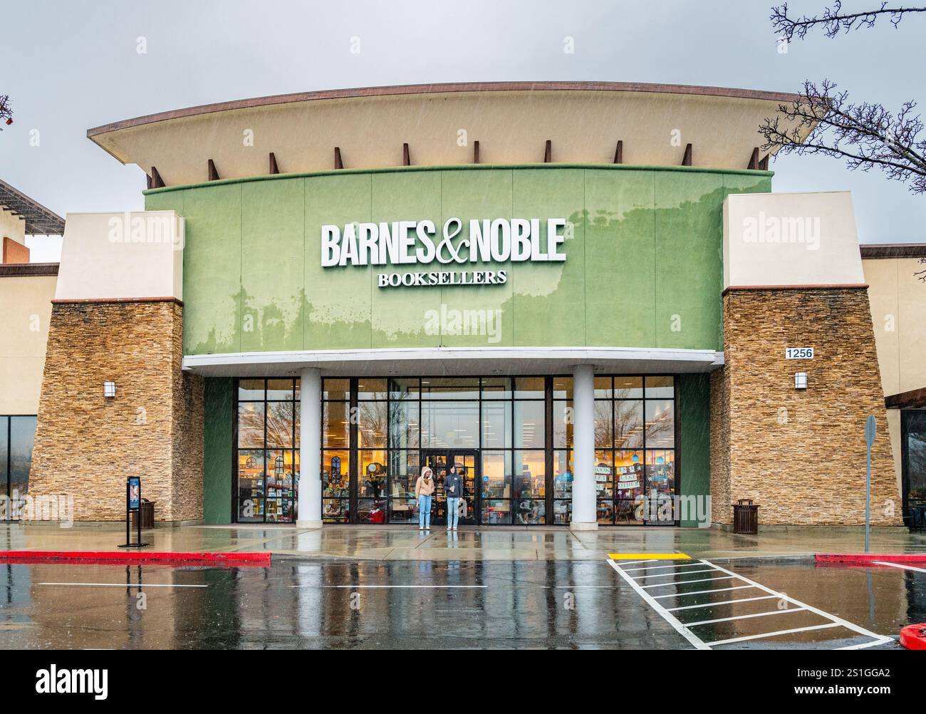 Photo of the front of a Barnes and Noble Store on a rainy day. The ...