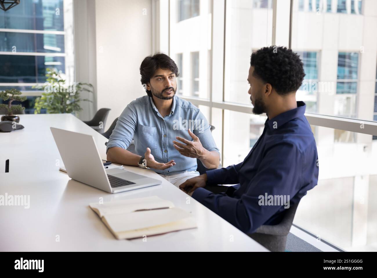Diverse project managers discussing work strategy, planning teamwork ...