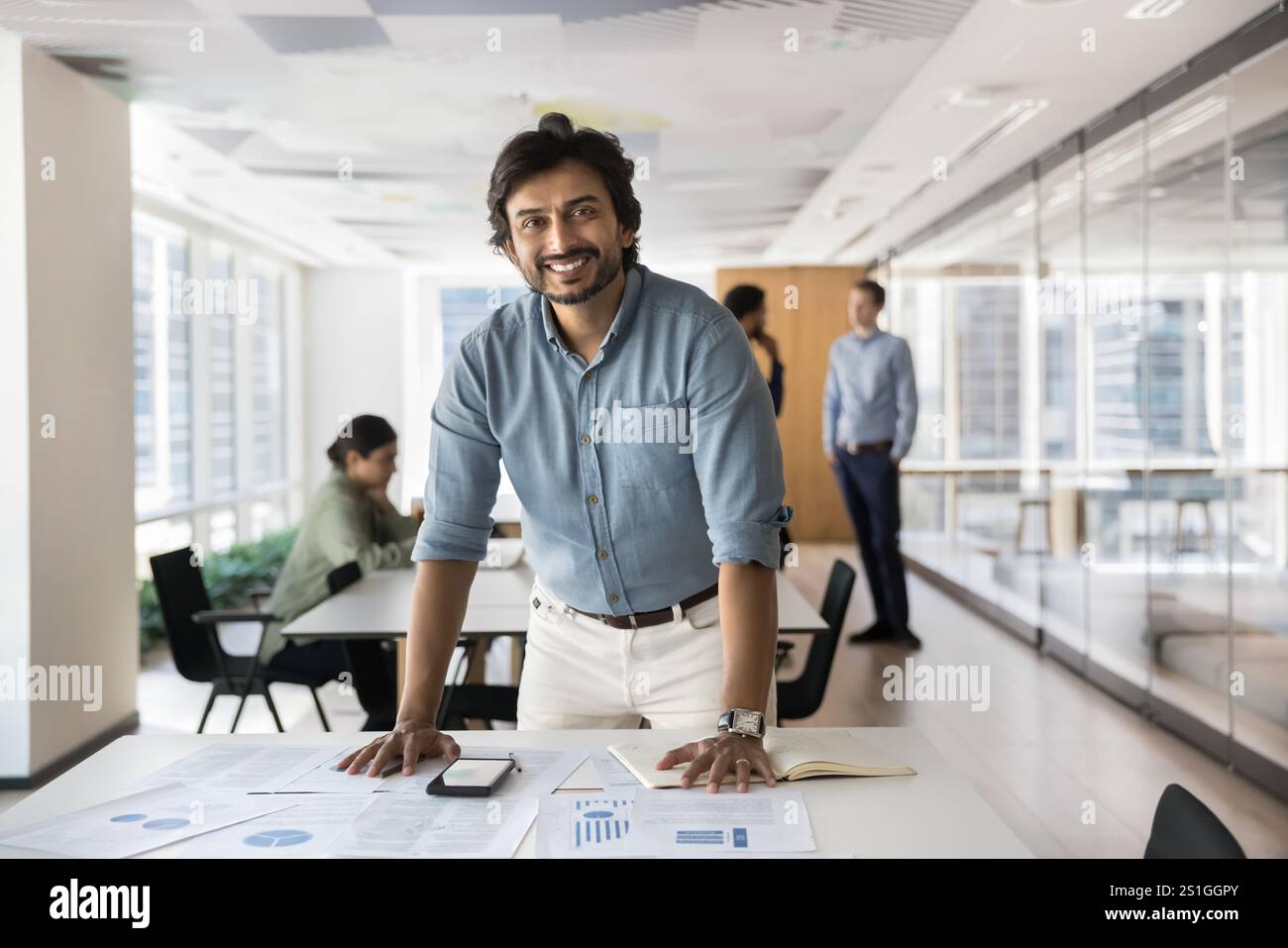 Happy Indian businessman, company owner, executive posing in open ...