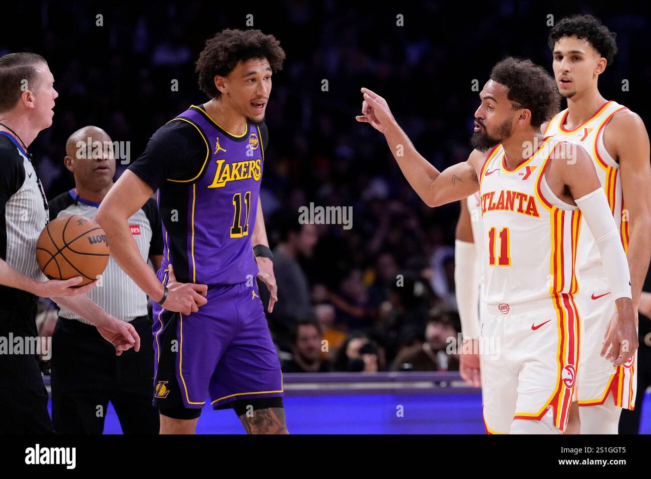 Los Angeles Lakers center Jaxson Hayes, center, jaws at Atlanta Hawks guard Trae Young, second ...