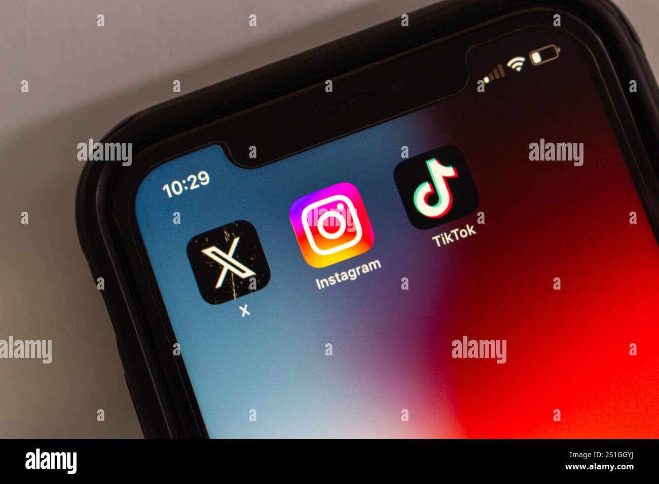 X app, Instagram and TikTok icons are displayed on an iPhone home ...
