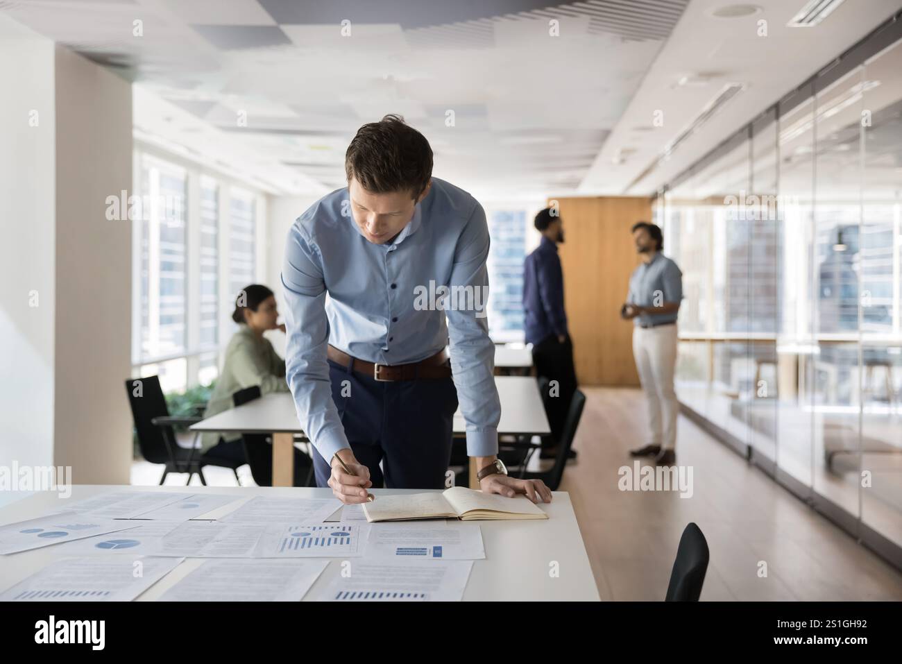 Focused busy young company owner man assessing business risk Stock ...