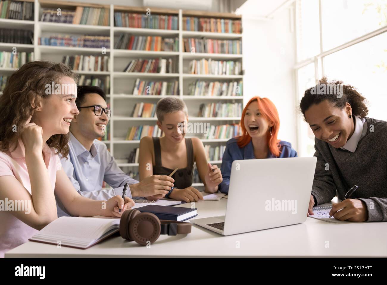 Group polyethnic students teenagers learn remotely at library using ...