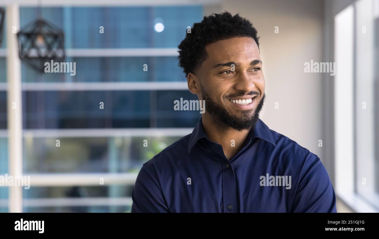 Happy dreamy African business leader man looking at window away Stock ...