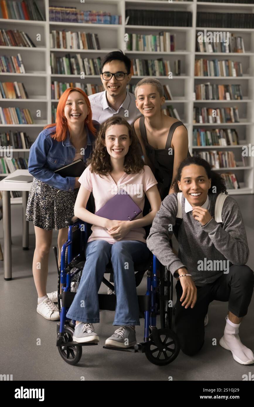 Teen female on wheelchair look at camera with friendly mates Stock ...