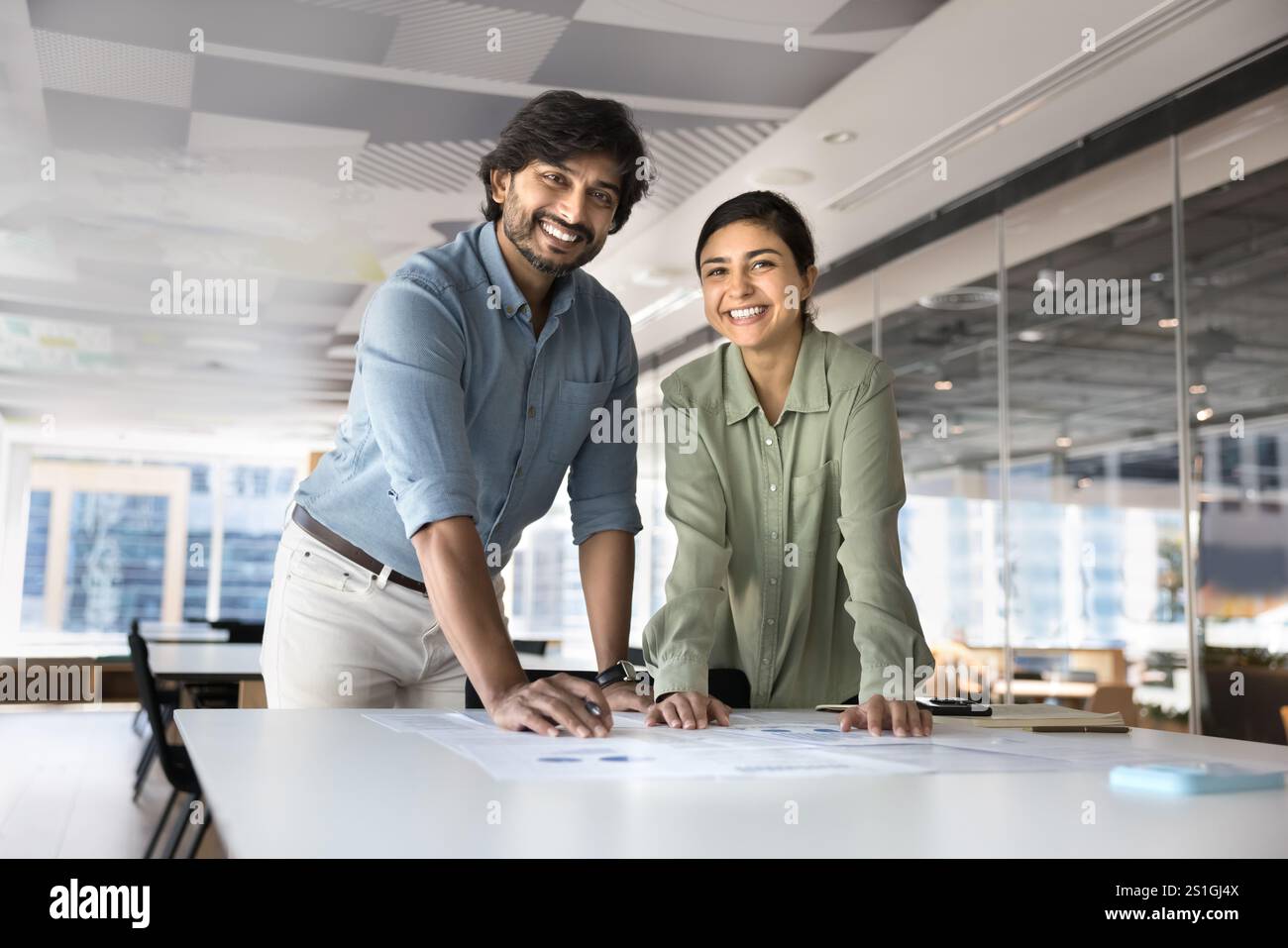 Two cheerful Indian startup colleagues meeting for teamwork Stock Photo ...