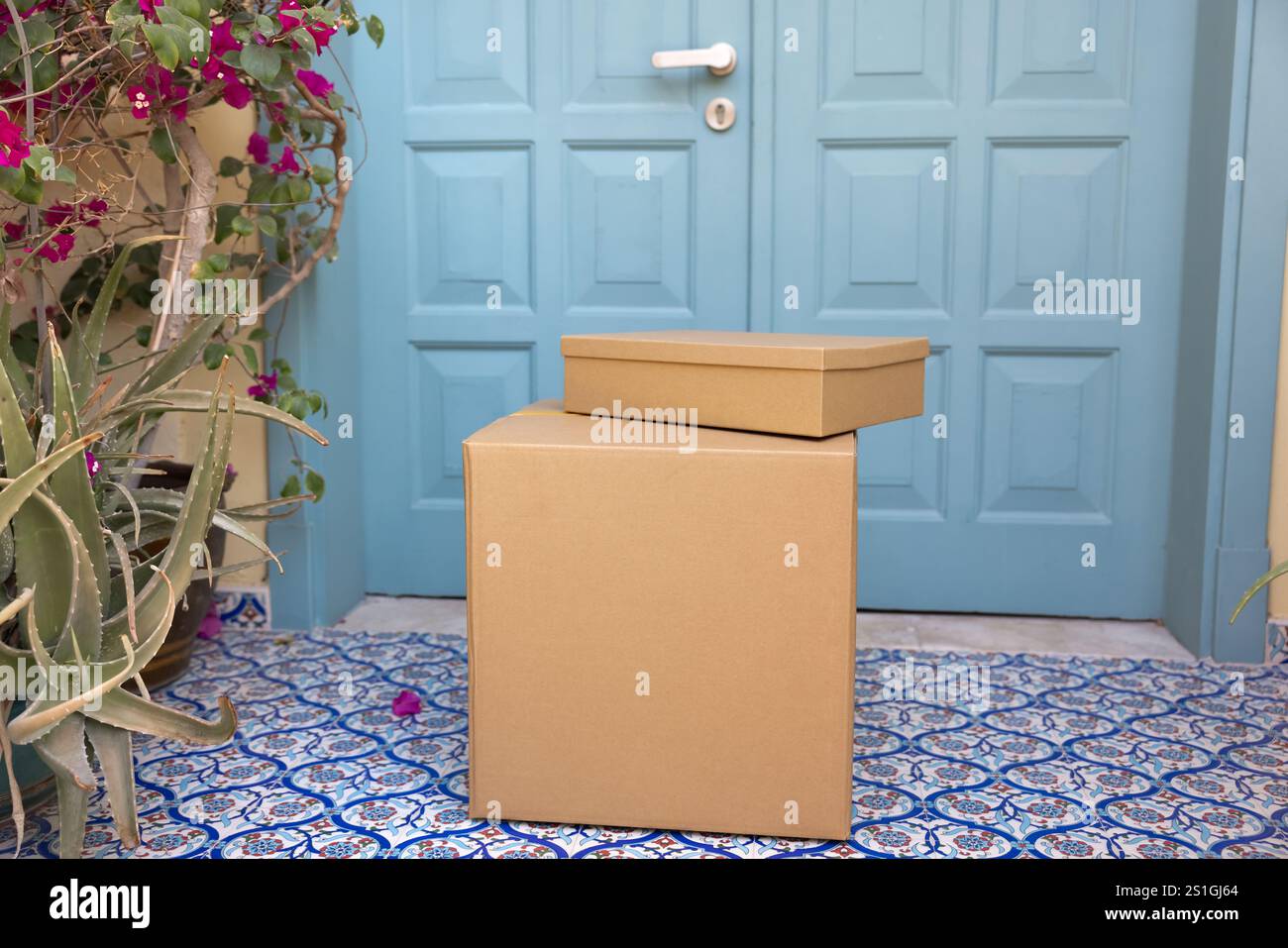 Stack of postal cardboard boxes carried by courier Stock Photo - Alamy