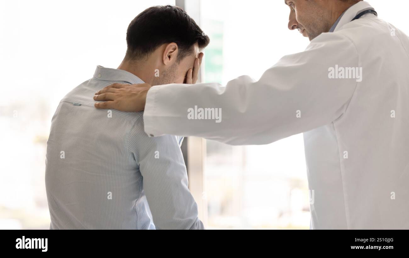 Compassionate male doctor telling hard serious diagnosis to patient ...