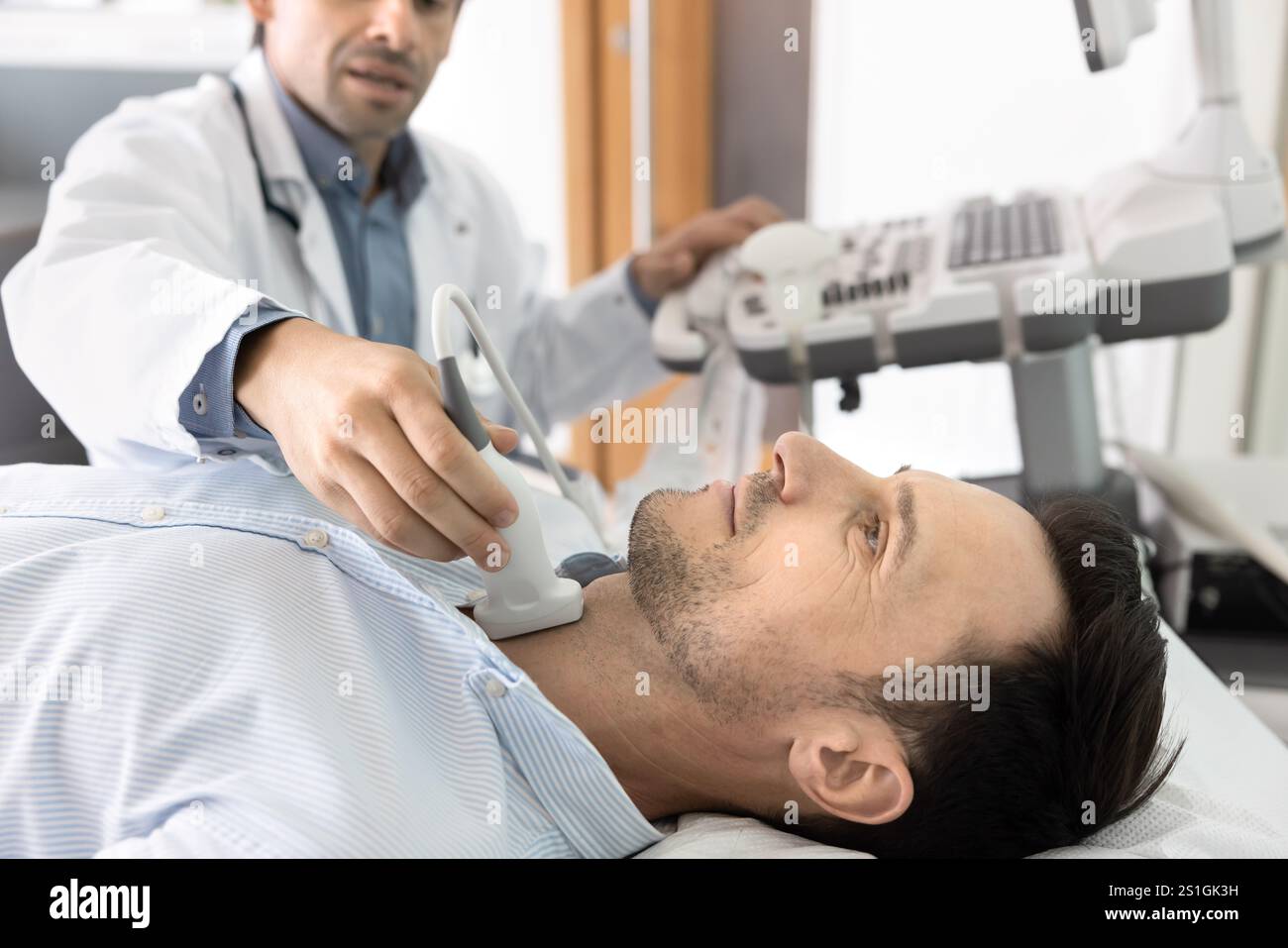 Clinic patient man lying on couch on ultrasound scanning procedure ...