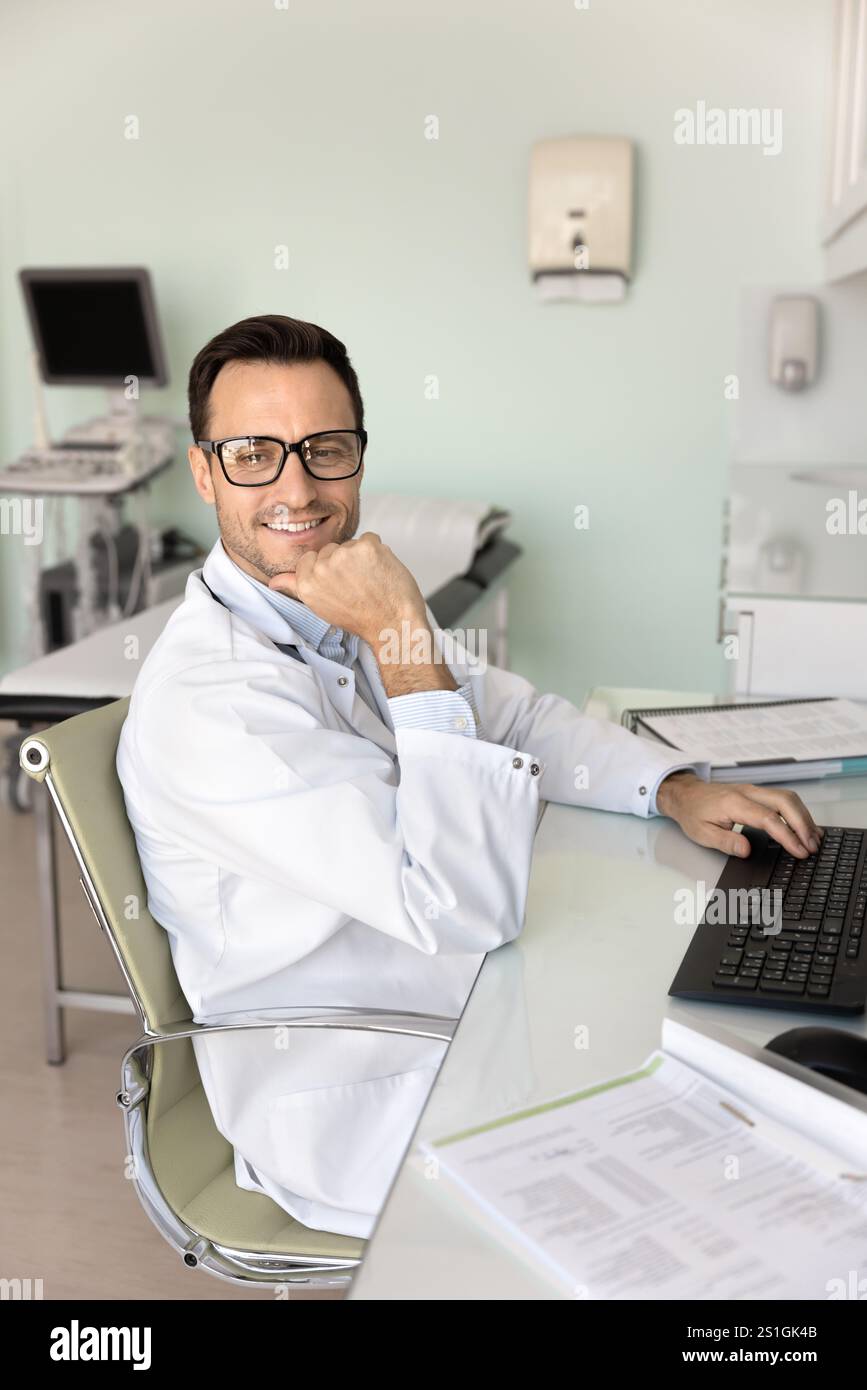 Handsome practitioner using ultrasound hi-res stock photography and ...