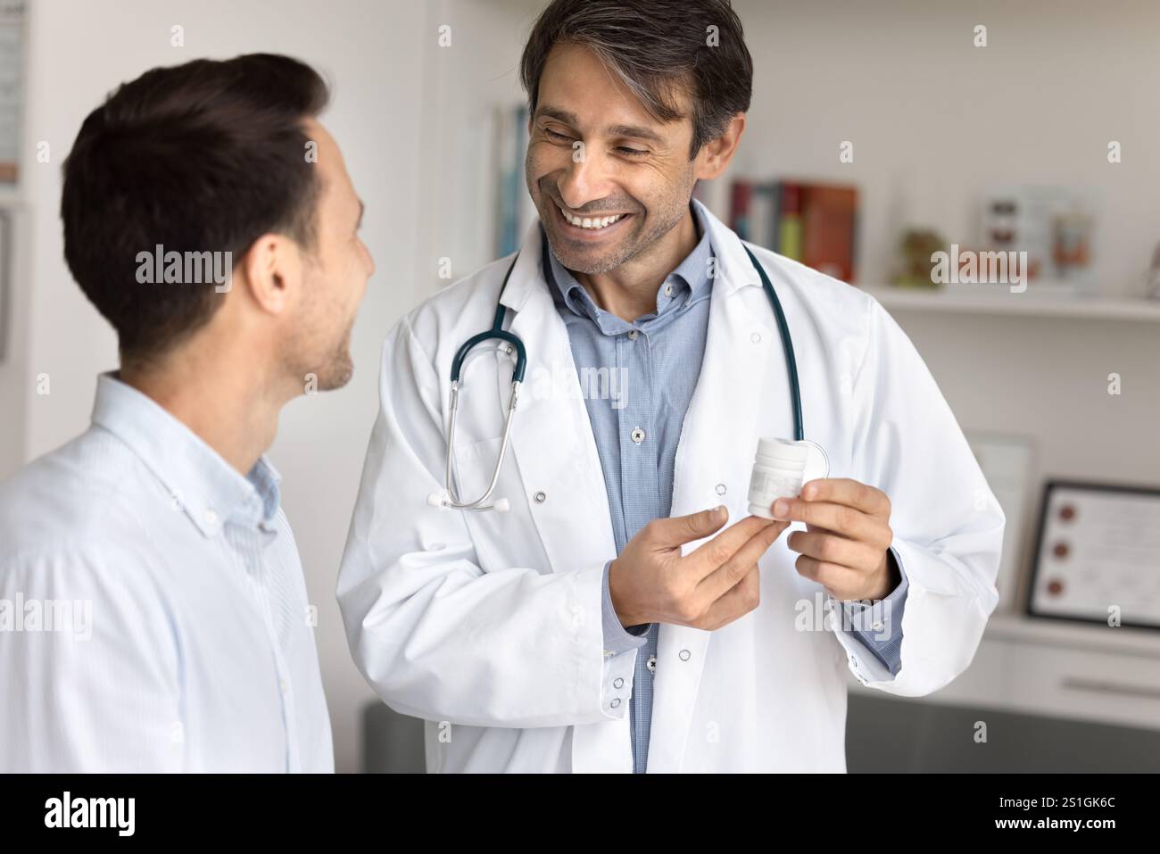 Happy medical professional specialist man recommending vitamins Stock ...