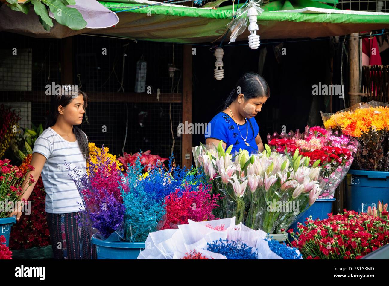 Women selling colourful bunches of flowers at a flower market in ...