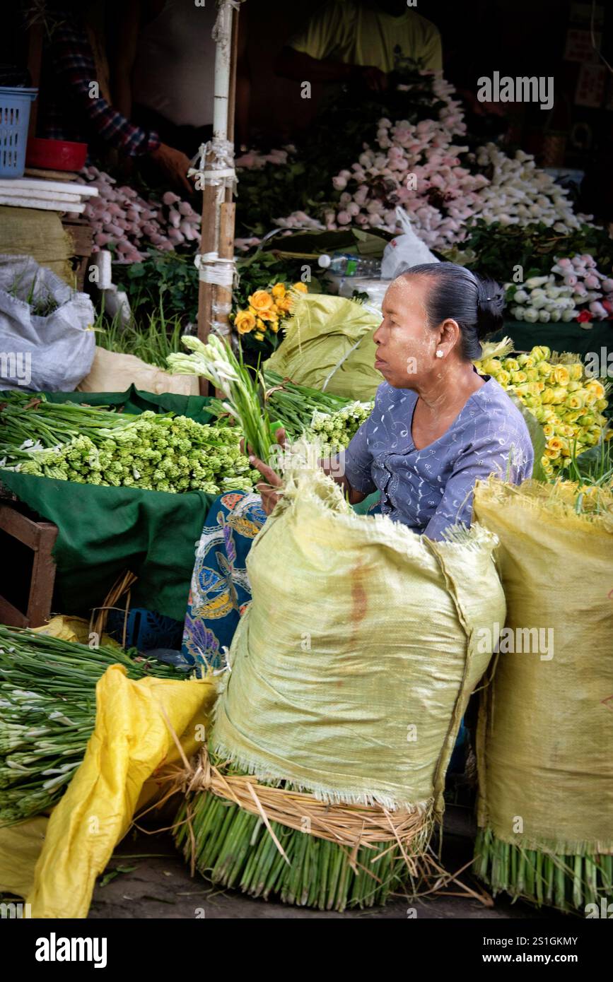 Women selling colourful flowers at a flower market in Mandalay, Myanmar ...