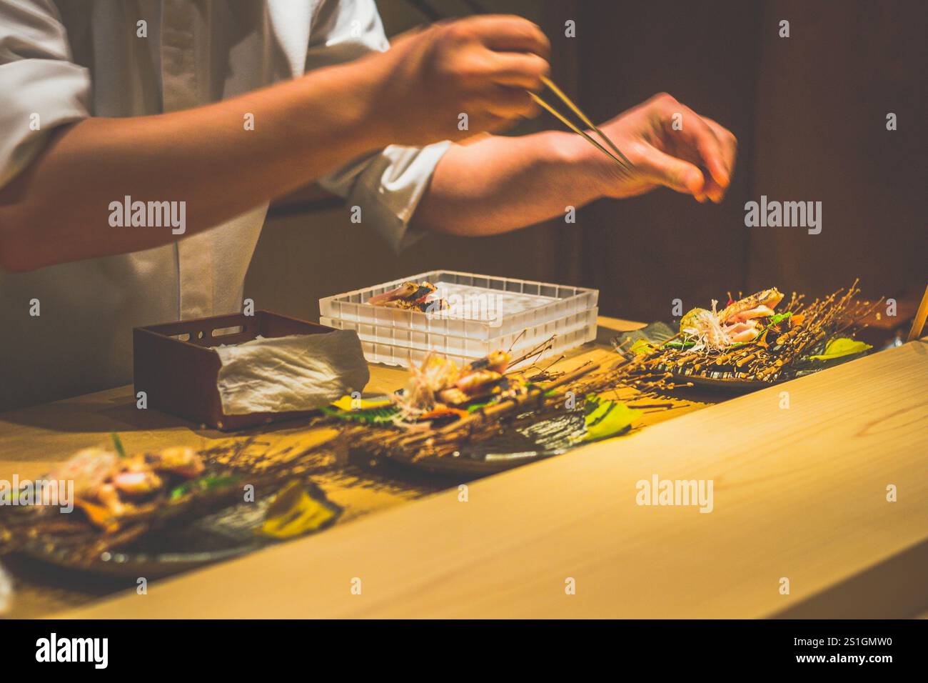 a japanese chef's hands preparing dishes in a kaiseki omakase ...