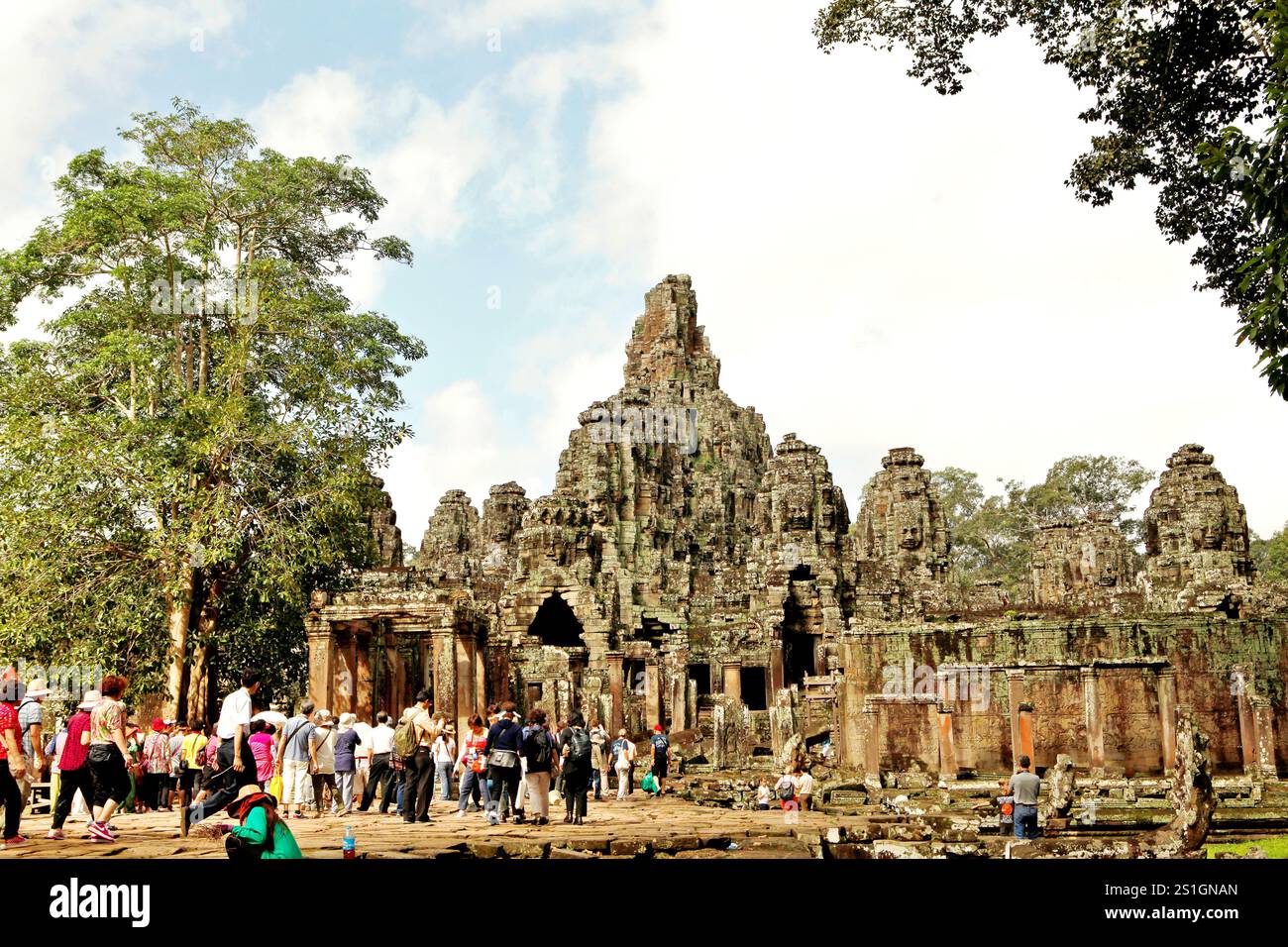 Tourists walking in groups, entering Prasat Bayon temple complex at the ...