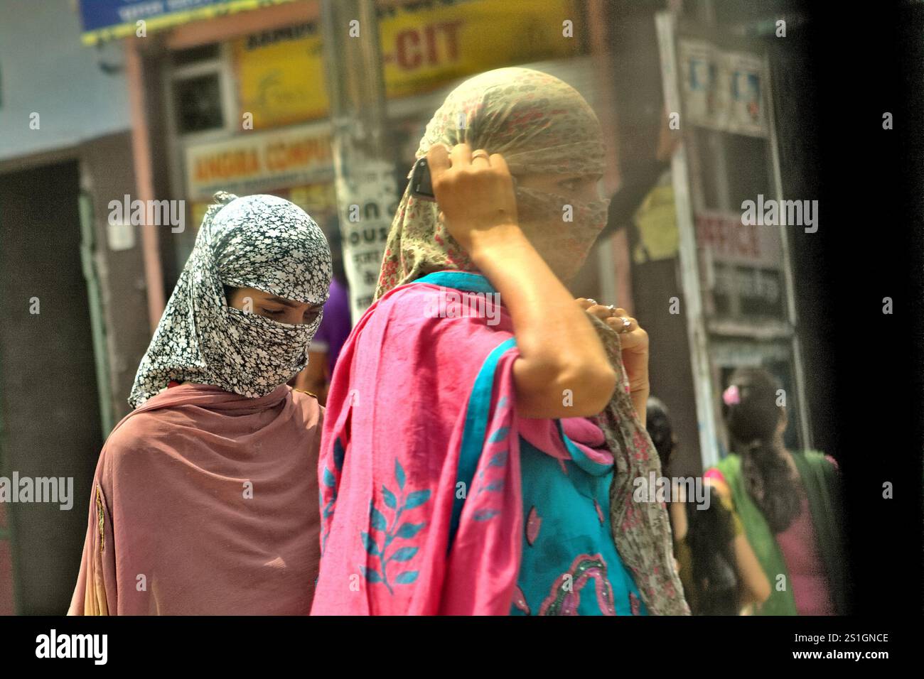 Women wearing niqab walking on the side of a road in Amer, Rajasthan ...