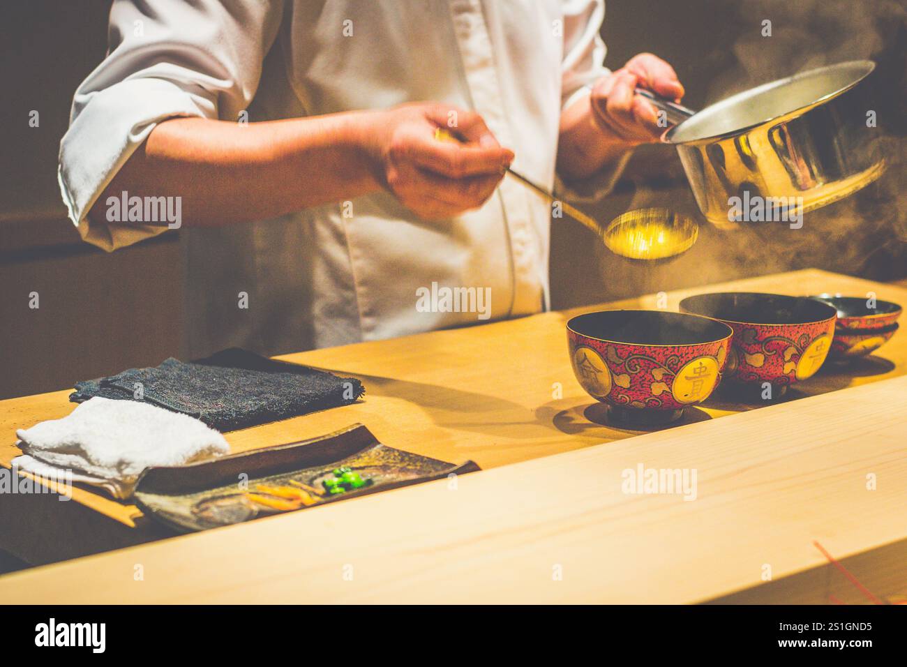 a japanese chef's hands preparing dishes in a kaiseki omakase ...
